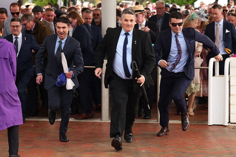 Kicking On - Wet Melbourne Cup racegoers fire up